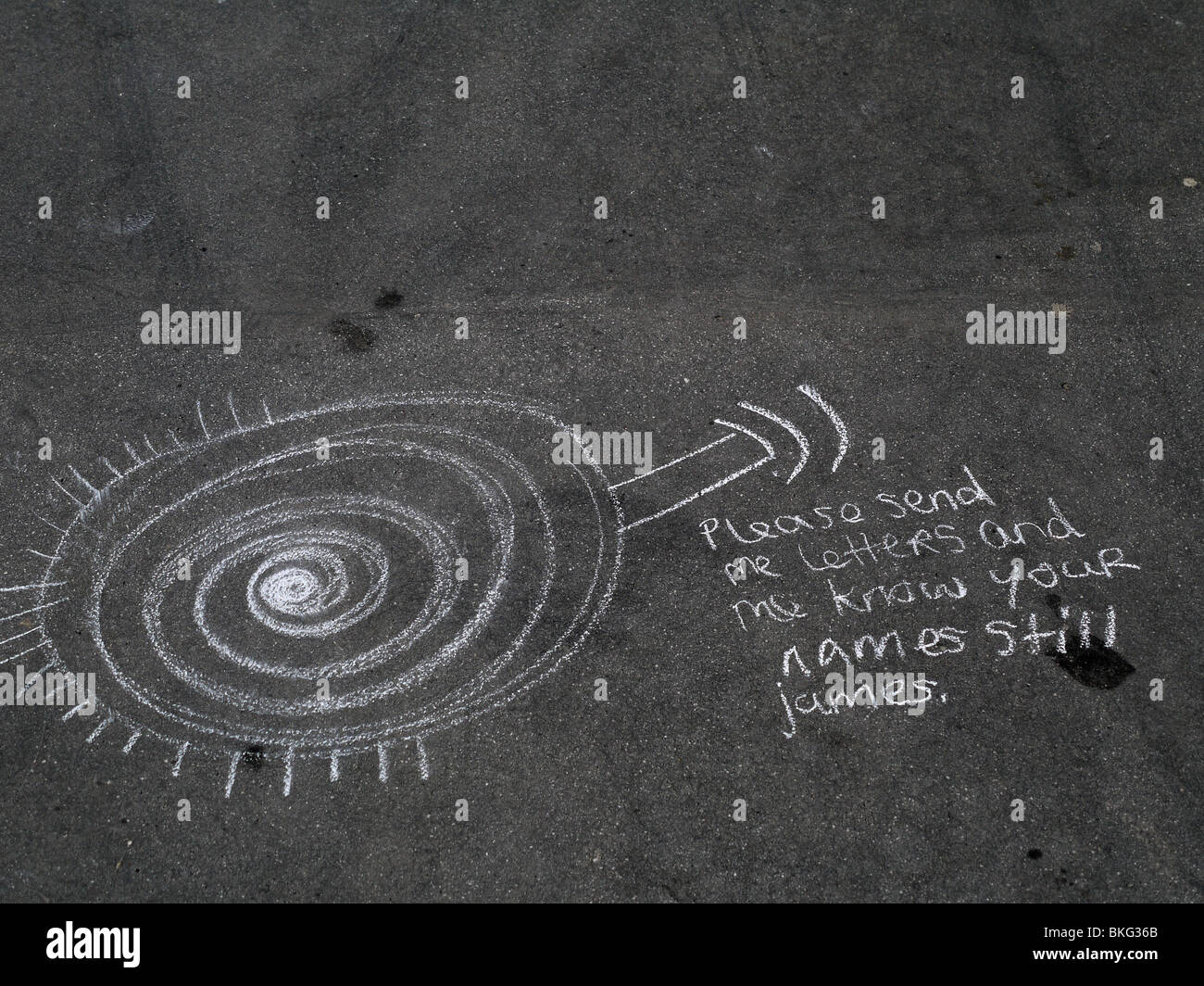 Strange little chalk doodle on pavement Stock Photo - Alamy
