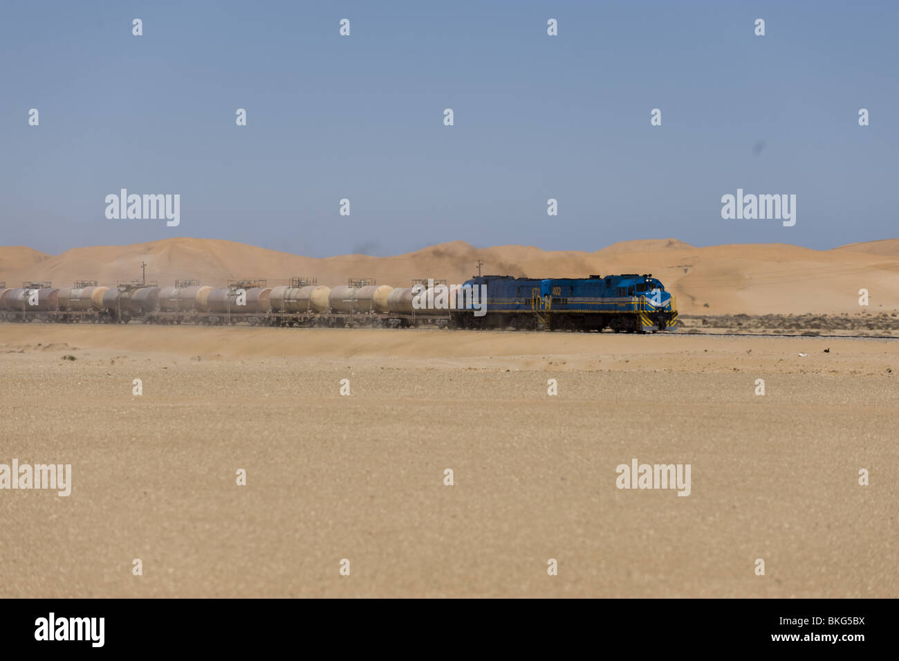 Goods train going through the desert between Walvis Bay and Swakopmund ...