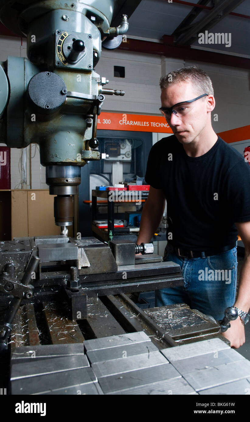 A precision engineer machining parts using a milling machine Stock ...