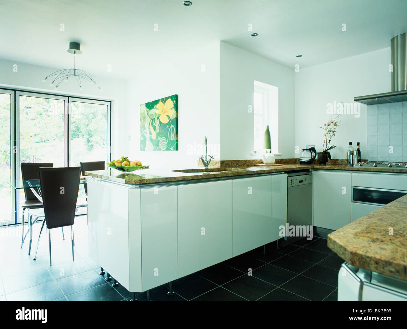 White fitted units in large modern white kitchen dining room Stock ...