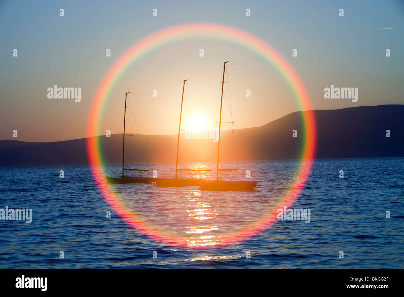 A rainbow surrounding boats on the turkish coast at Teos Stock Photo ...