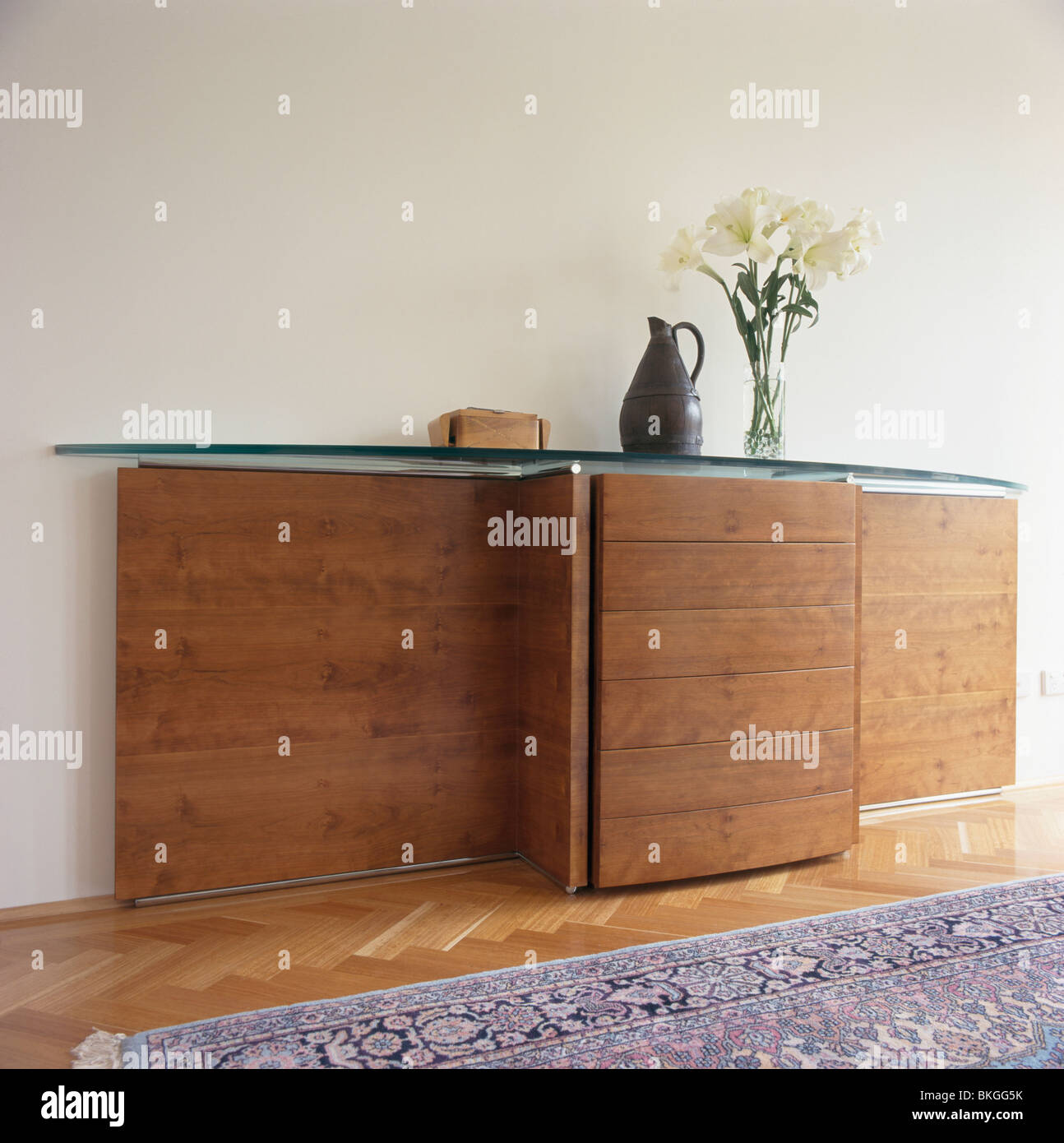 Fitted glass-topped pale wood console table in modern white hall Stock ...