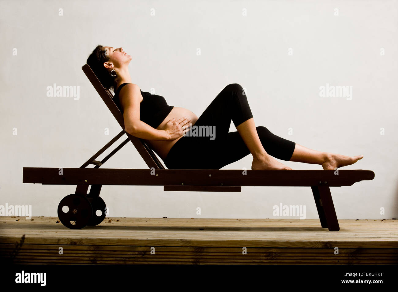 A pregnant mother relaxes on a sun lounger before giving birth to her ...