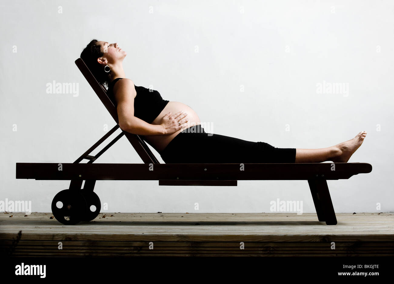 A pregnant mother relaxes on a sun lounger before giving birth to her ...