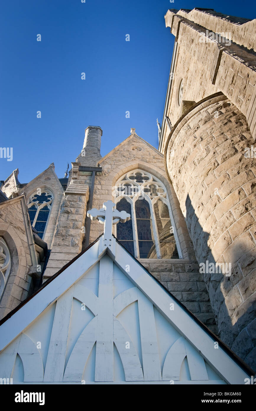 Looking up at an old church, focus on a white cross. Church of our Lady ...