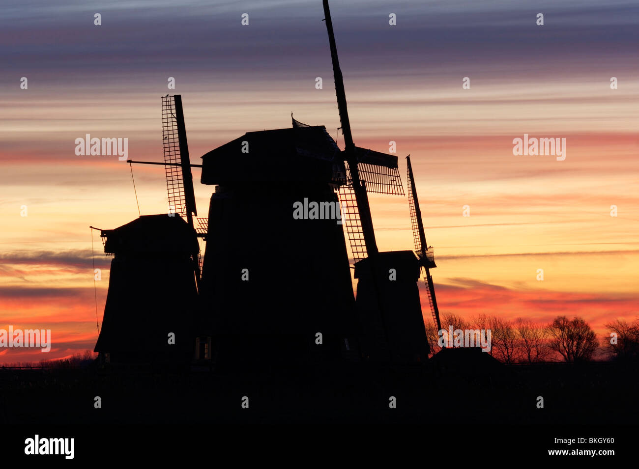 Windmills at sunrise Stock Photo - Alamy