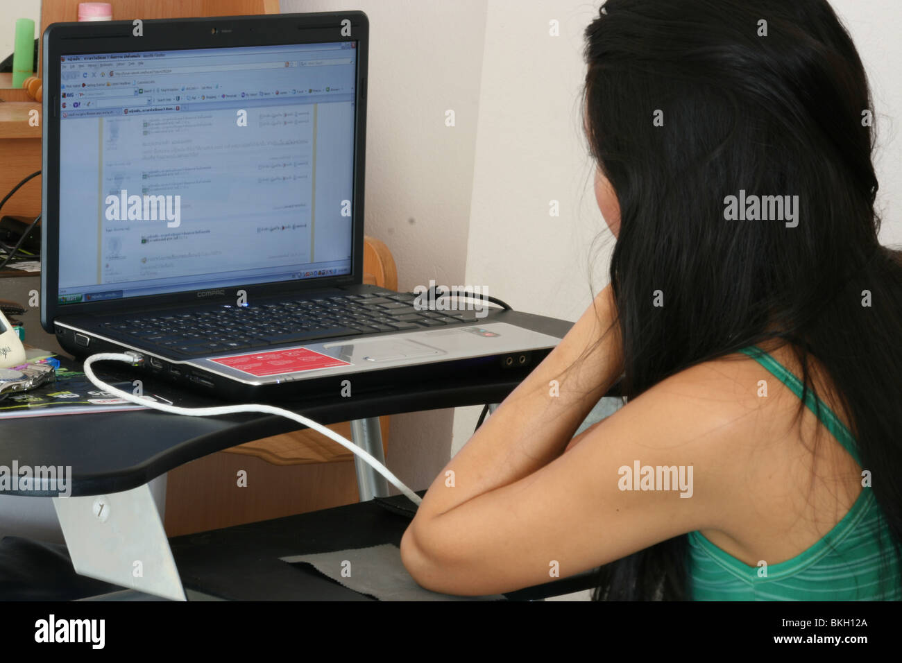 Asian girl on a laptop computer in Thailand Stock Photo - Alamy