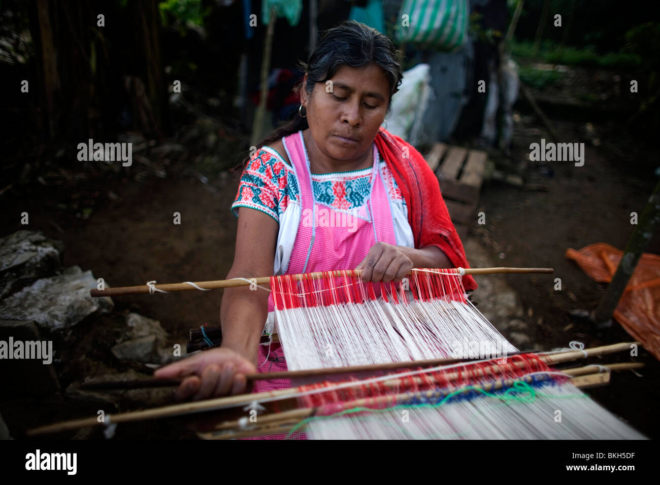 A woman weaves a shawl outside her home in San Andrés Tzicuilan, on the ...