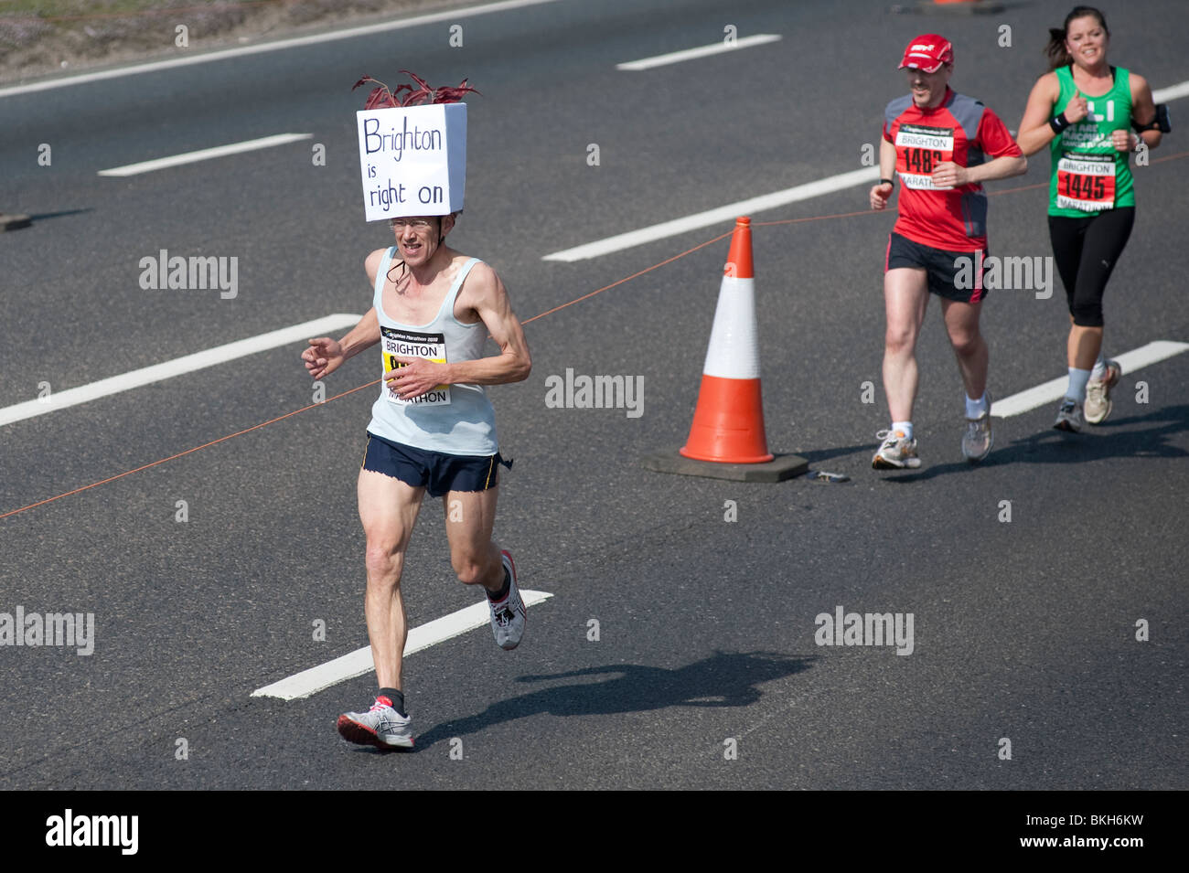 A runner in fancy dress hat at the Brighton Marathon Stock Photo - Alamy