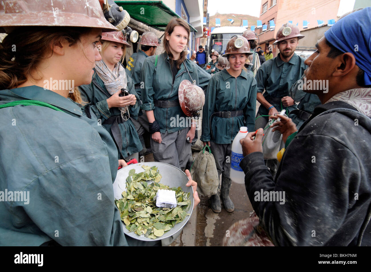 Tourists dressed buying gifts for miners (drinks, coca leaves) before ...