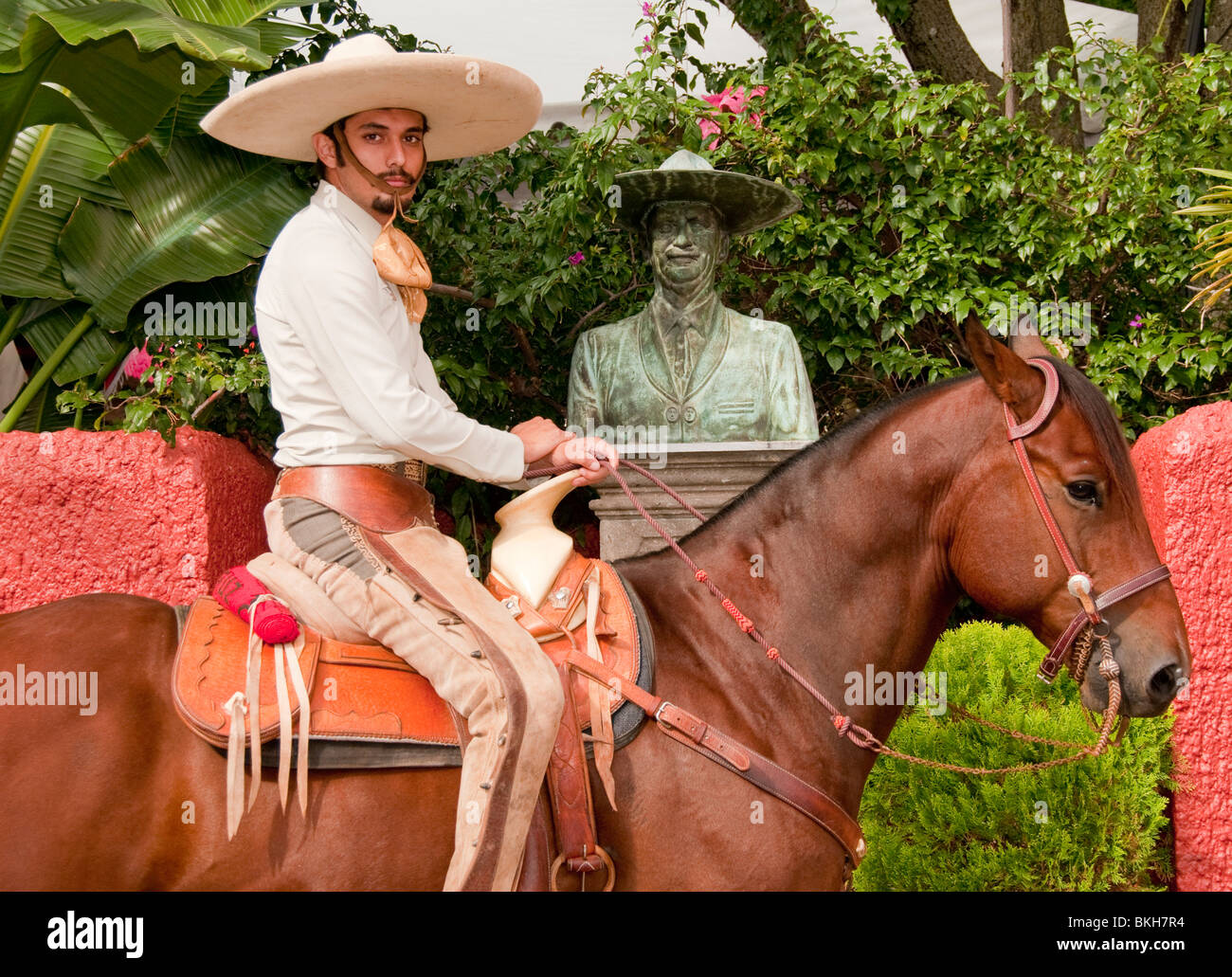 Guadalajara, Mexico, Charro Mexican Cowboy resting on riding horse at ...