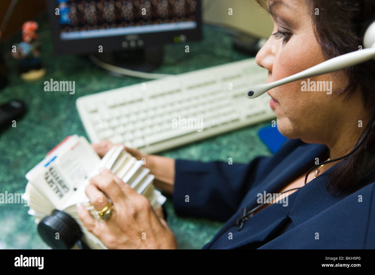 Hispanic receptionist woman with phone headset in office Stock Photo ...