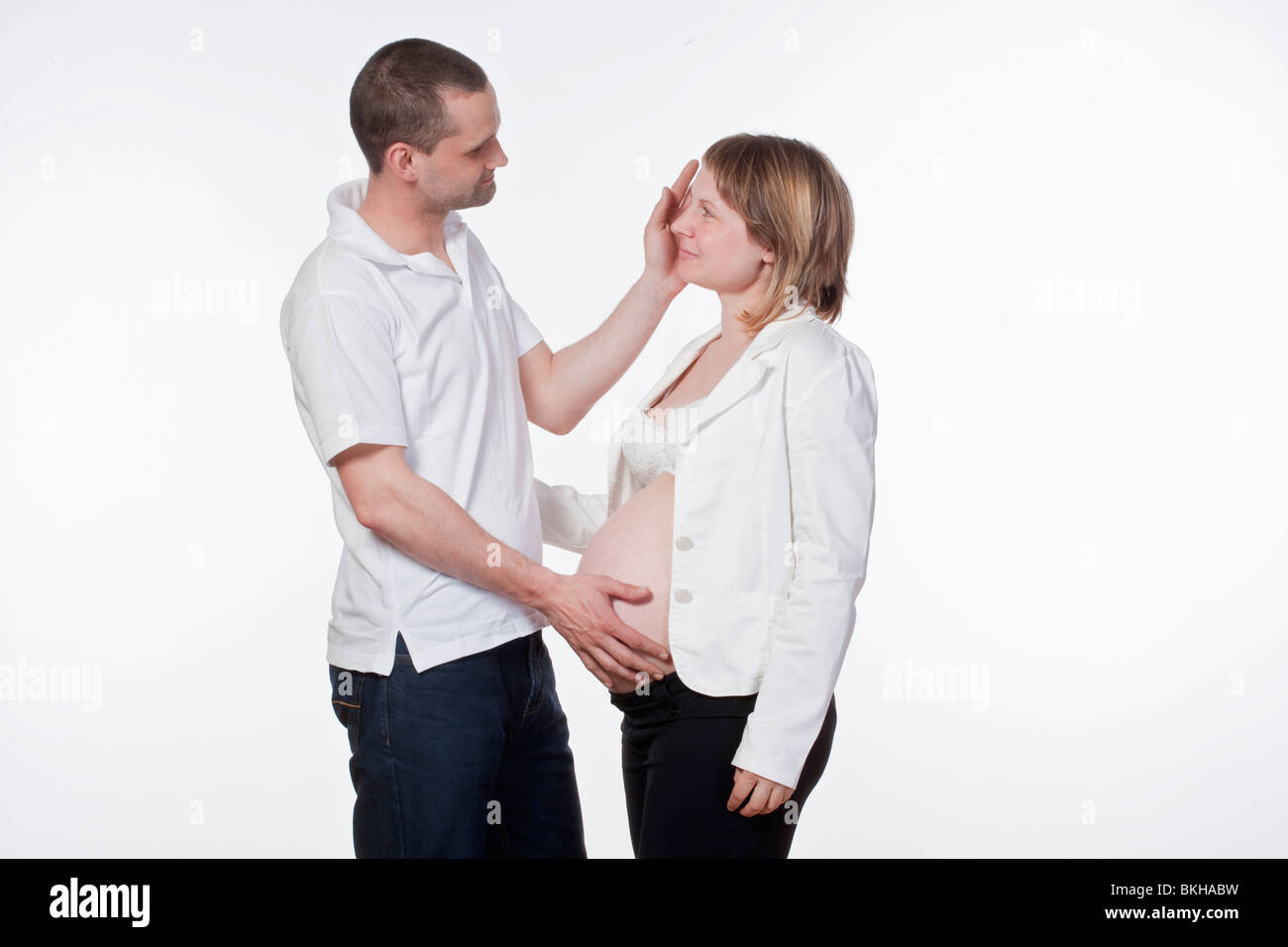 happy expecting couple holding each other - isolated on white Stock ...