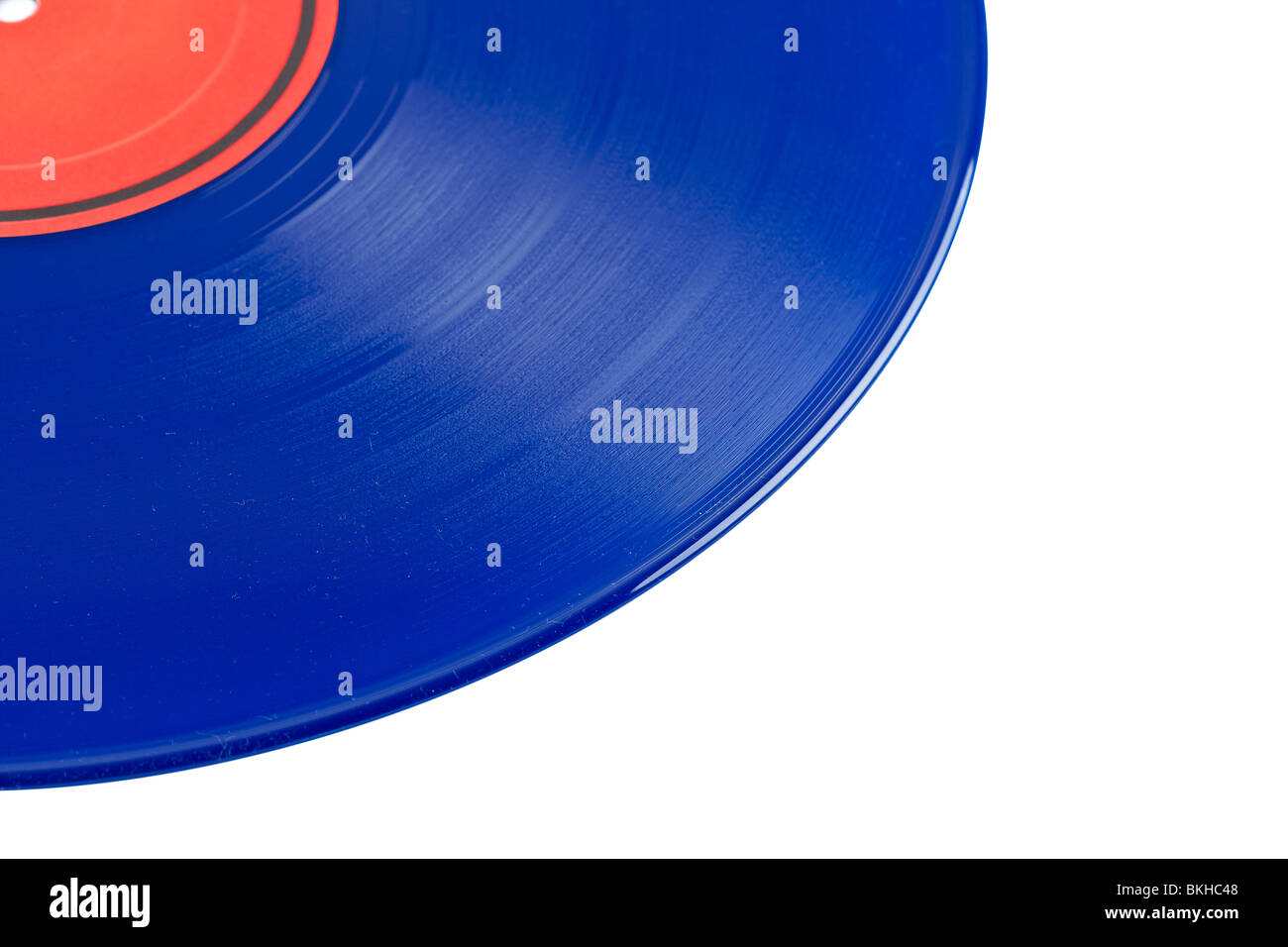 Dusty vinyl record with red label isolated on white background. Shallow ...