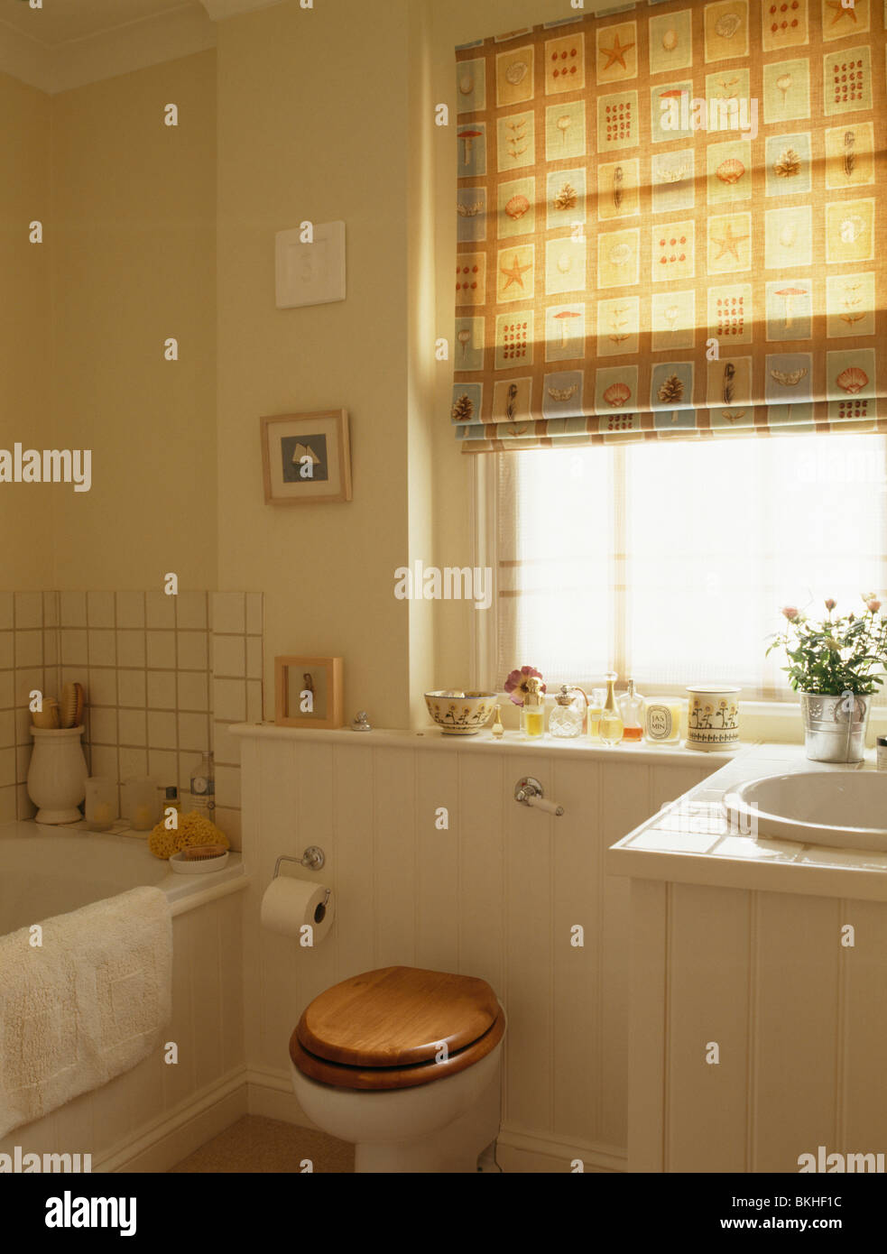 Toilet with wooden seat below window with Osborne+Little neutral blind ...