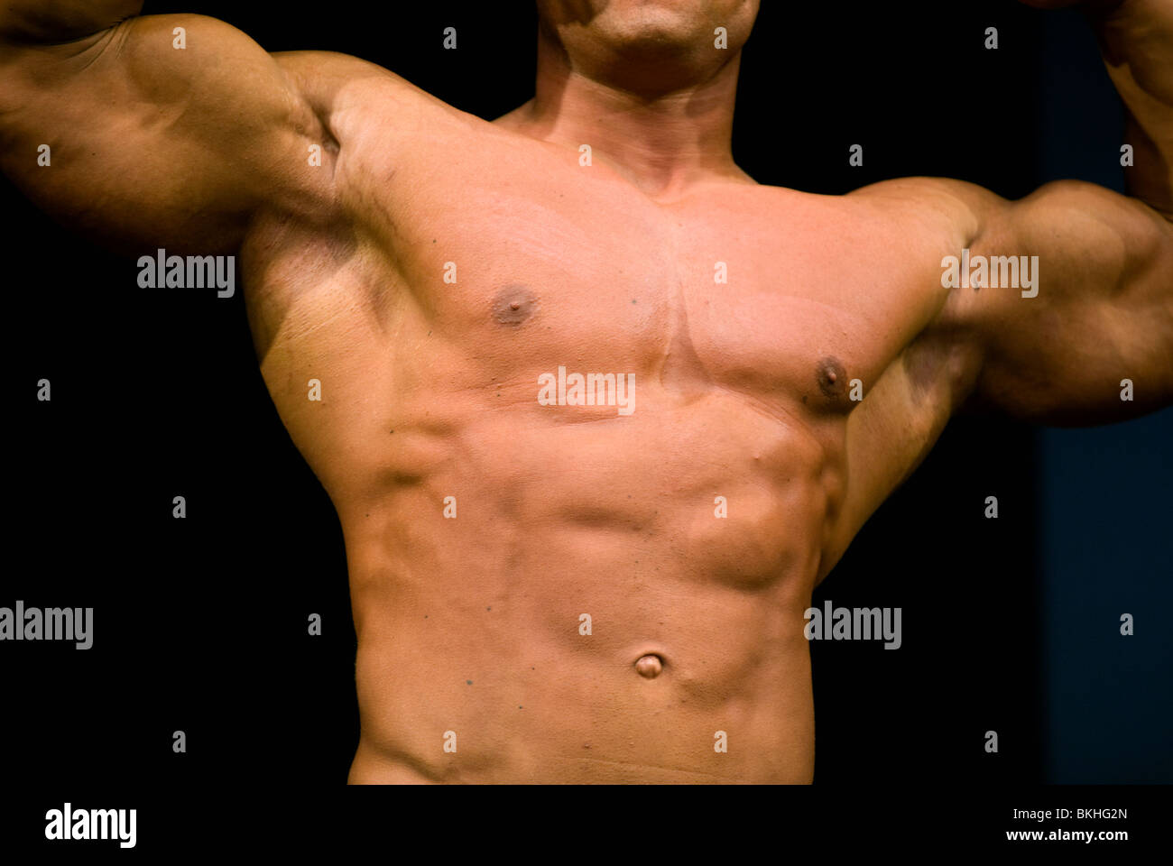 detail of a male bodybuilder during the fitness fair FIBO Power in ...