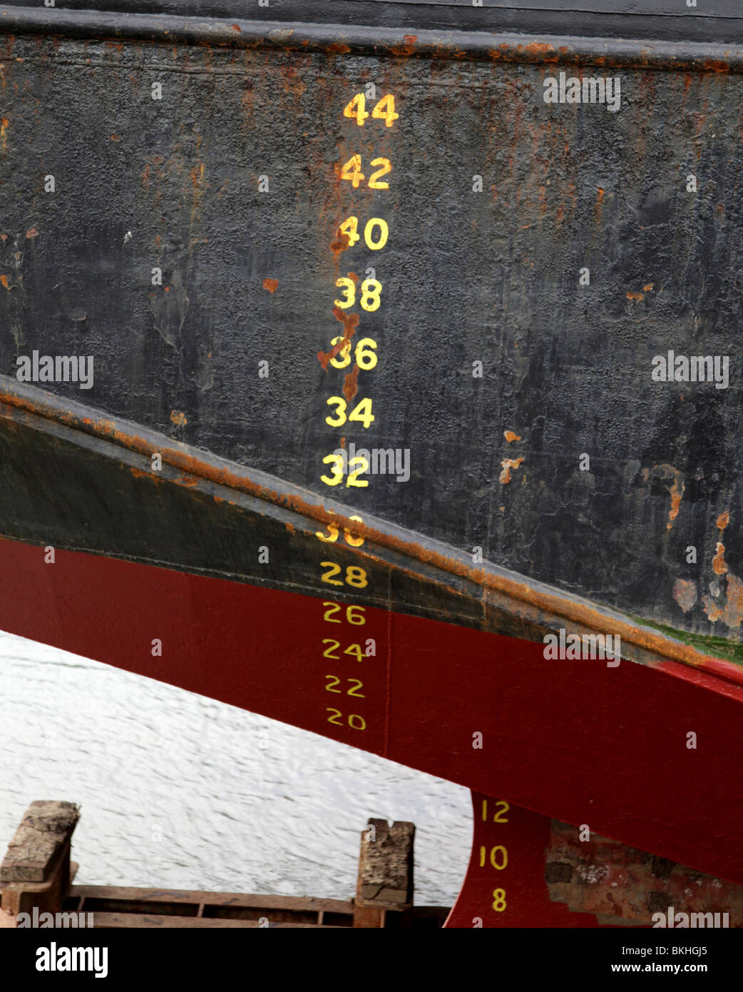 Painted depth indication markings on the side of a ship in a dry dock ...