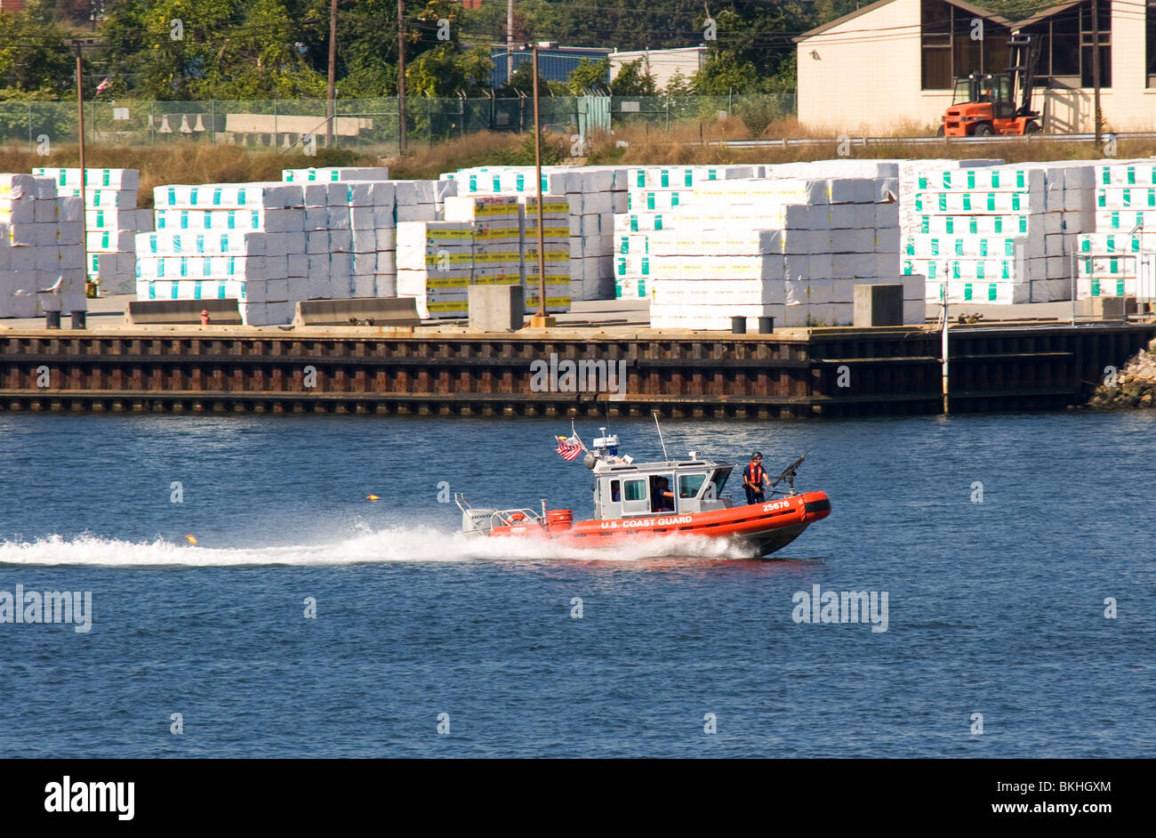 A US Coast Guard rigid hull inflatable armed escort speeds north in the ...