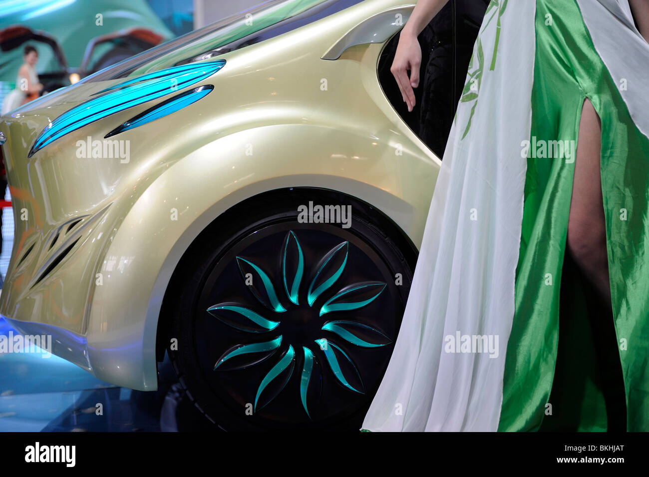 A model poses beside an IAT "Zu" electric concept car, designed by IAT ...