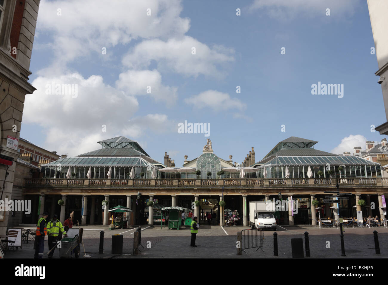 Early birds at the Piazza in Covent Garden in London.Street cleaners ...