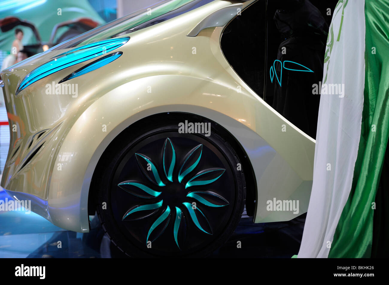 A model poses beside an IAT "Zu" electric concept car, designed by IAT ...
