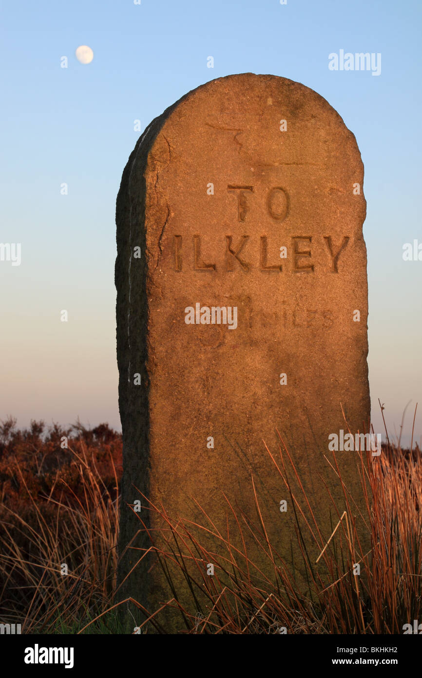 The moon rises over a stone signpost or milestone on "Rombolds" or ...