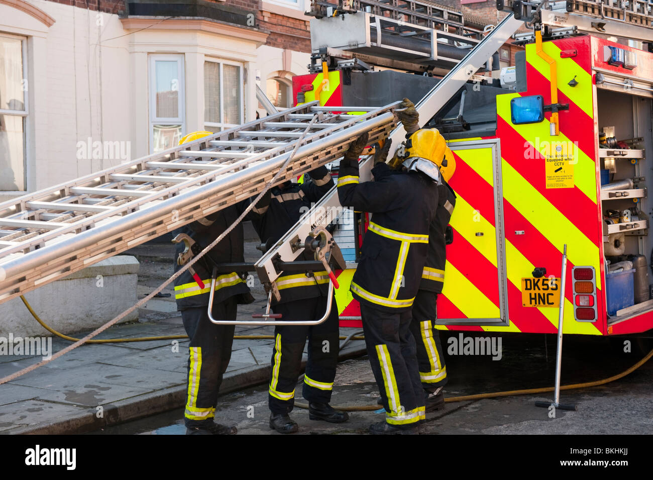 Firemen removing 135 ladder from appliance Stock Photo - Alamy
