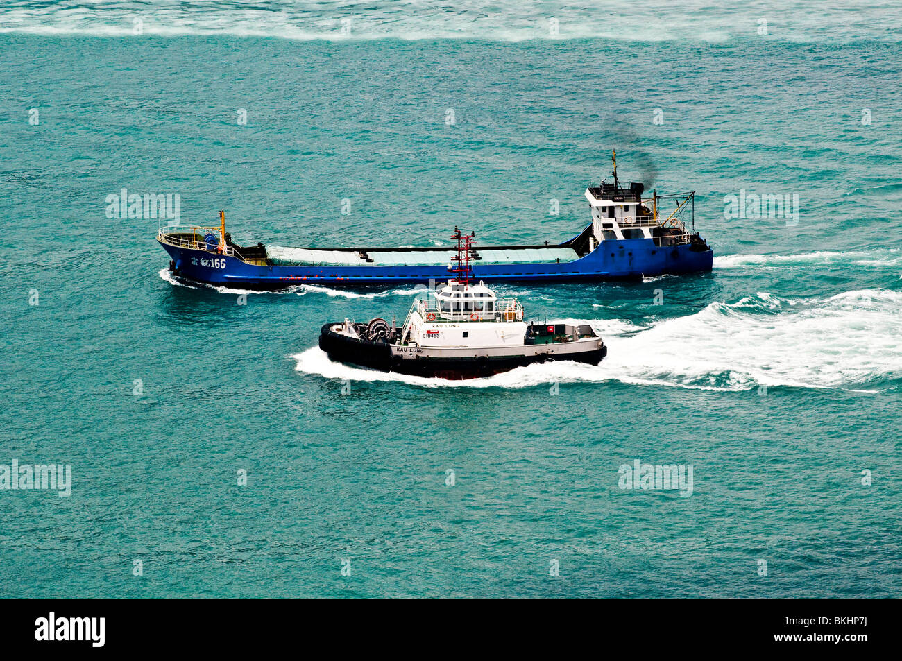 Big ship small boat in Victoria harbor in Hong Kong Stock Photo - Alamy
