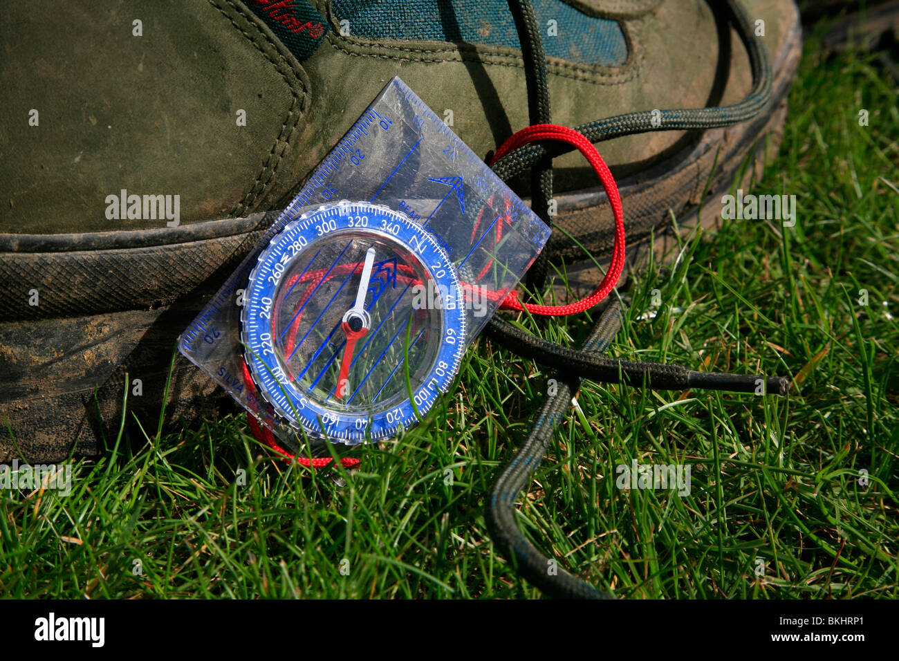 A walking boot and a compass Stock Photo - Alamy