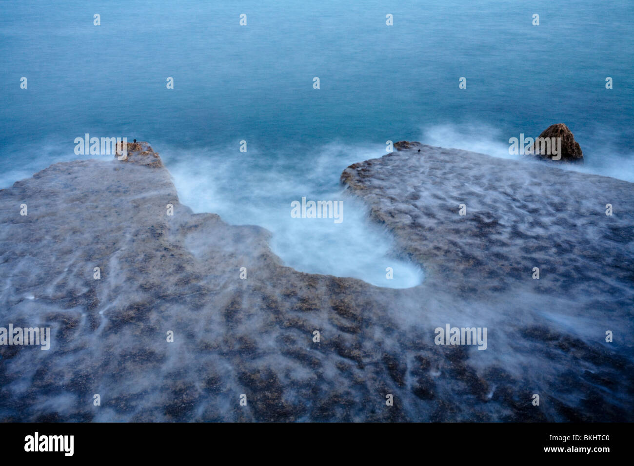 Waves on limestone ledges in twilight Portland Bill. Isle of Portland ...