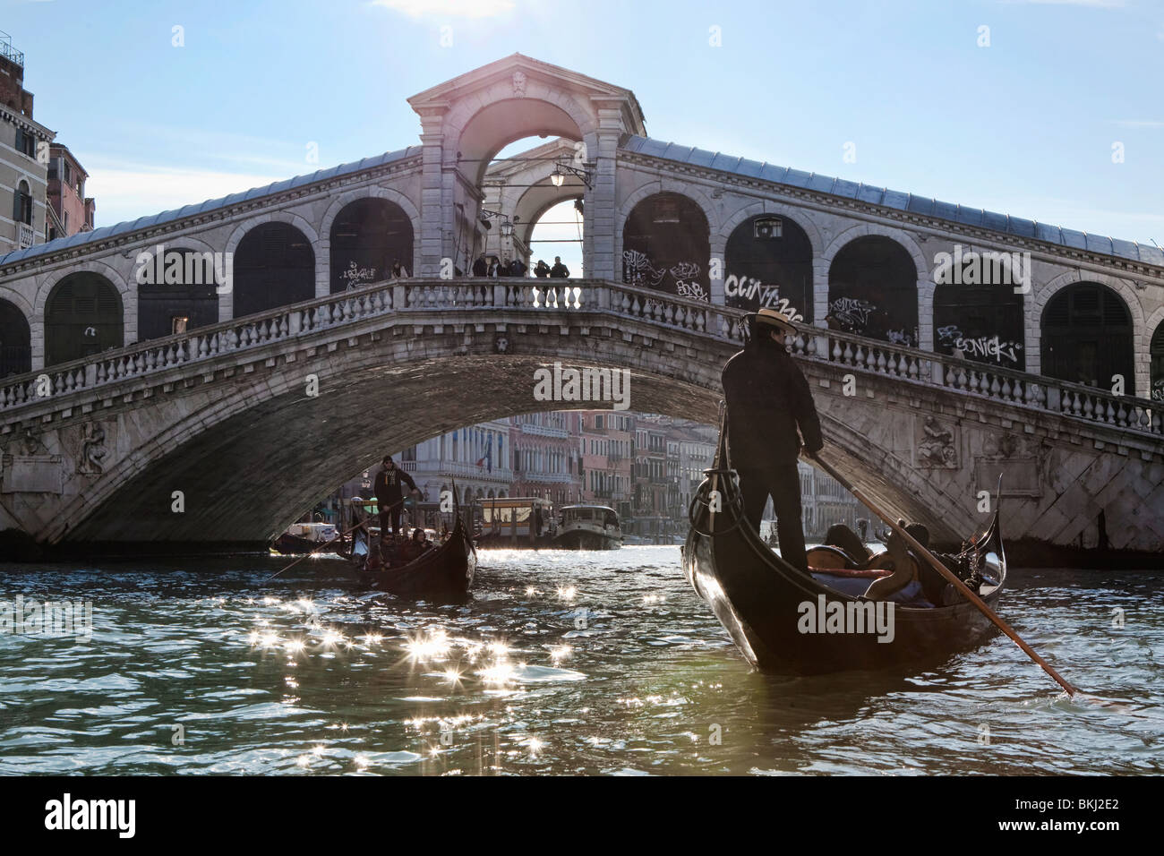 Gondolas passing underneath the Rialto Bridge on the Grand Canal in ...
