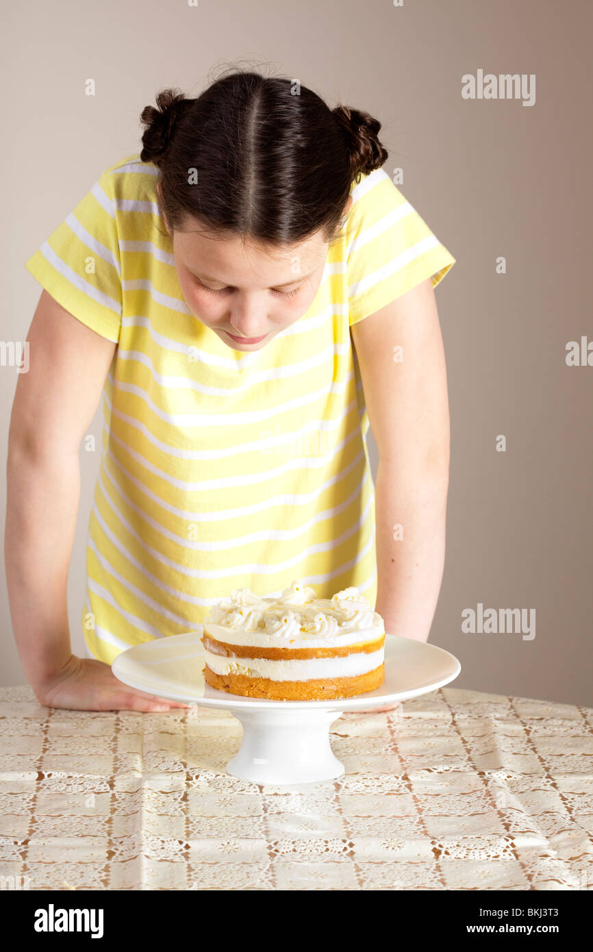 girl looking at cake Stock Photo - Alamy