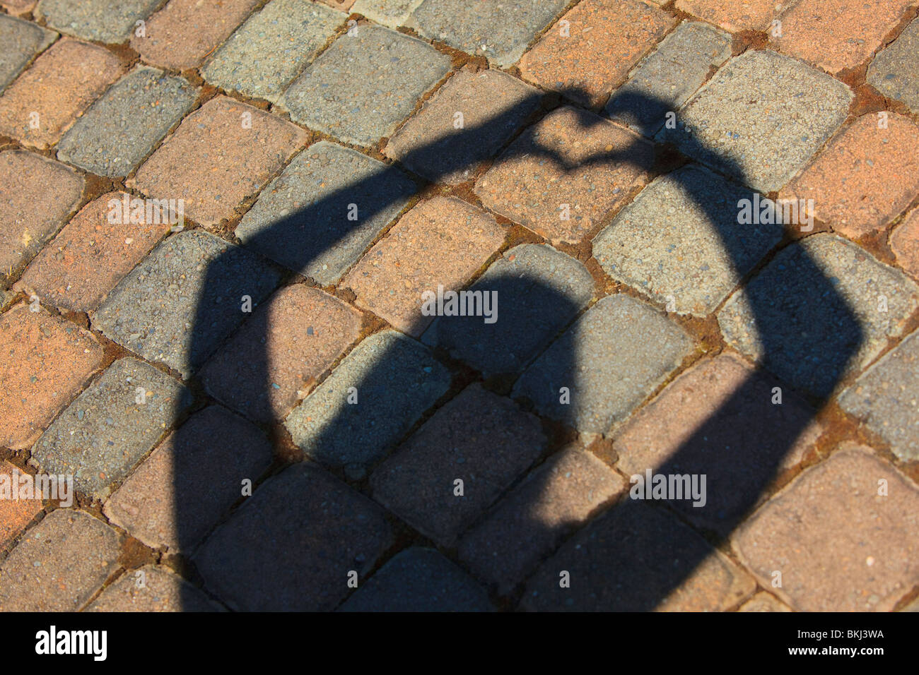 A Shadow Of Hands Making A Heart Shape Stock Photo - Alamy