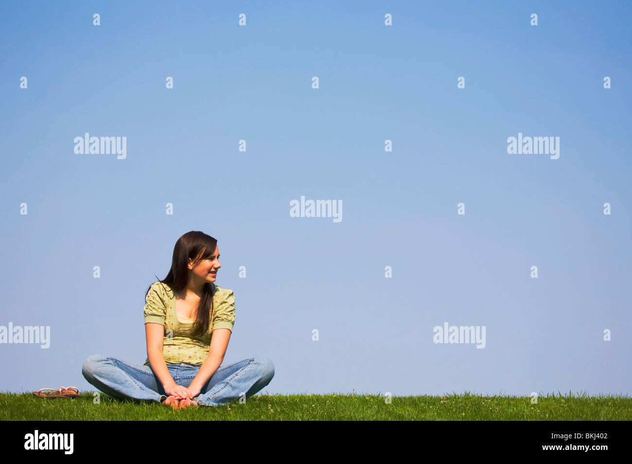 A Girl Sitting On The Grass Stock Photo - Alamy