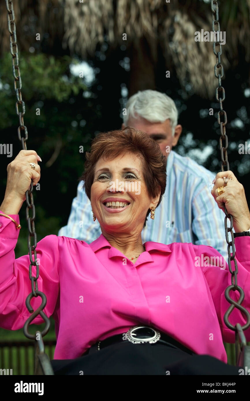 Man pushing a woman on a swing hi-res stock photography and images - Alamy