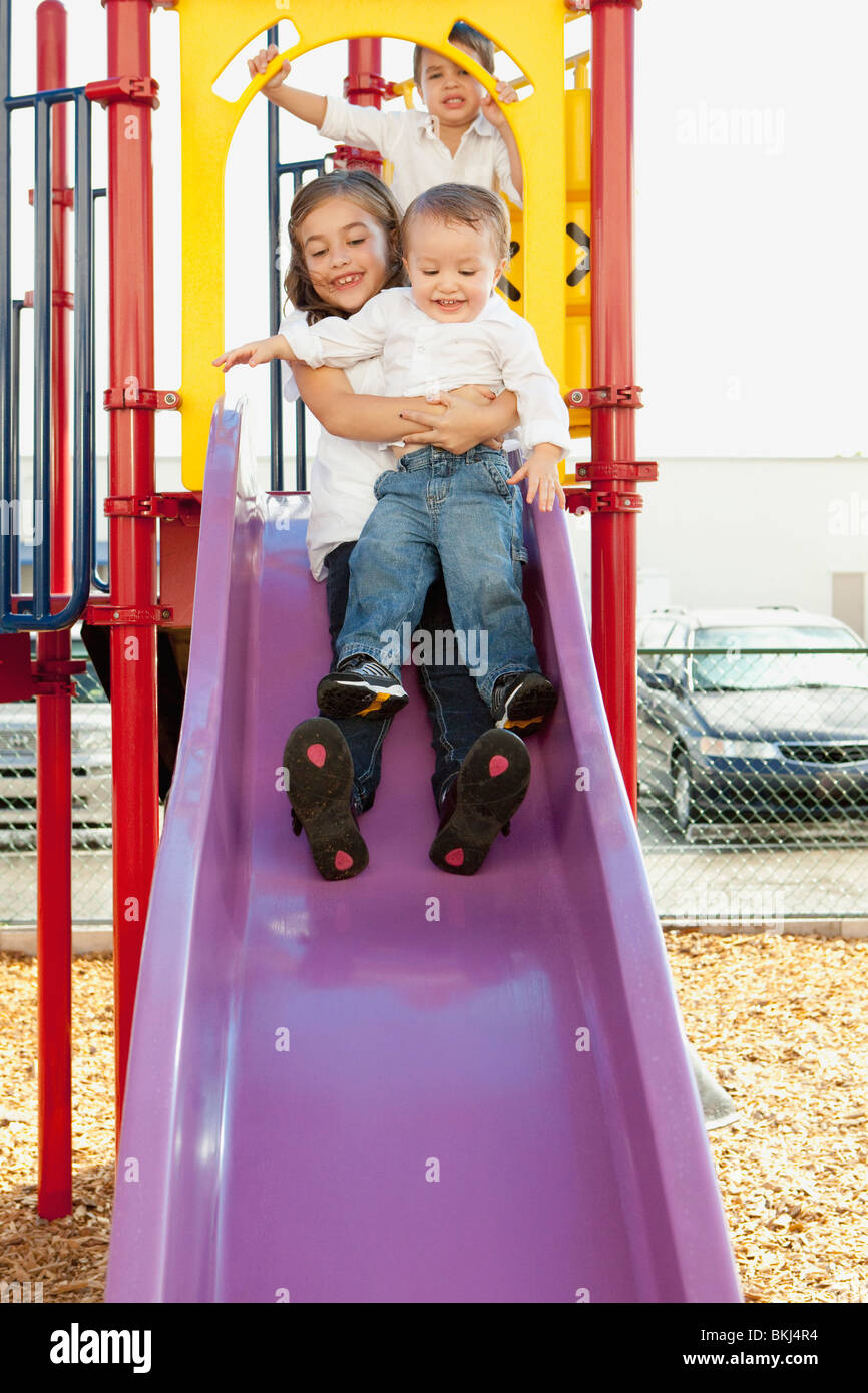 Three Children Playing At The Playground Stock Photo - Alamy