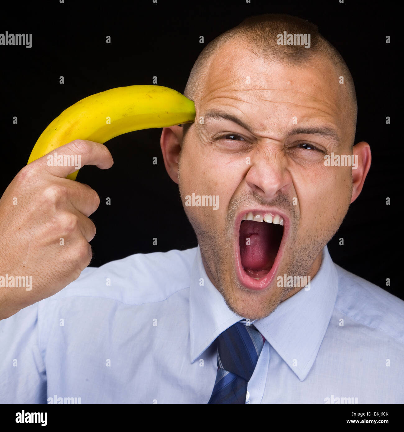 An angry businessman with a Mohican haircut Stock Photo - Alamy