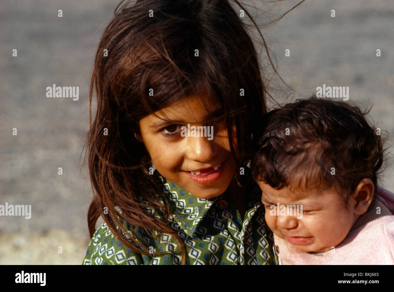 West Bank Israel Young Girl Smiling Holding Baby Stock Photo - Alamy