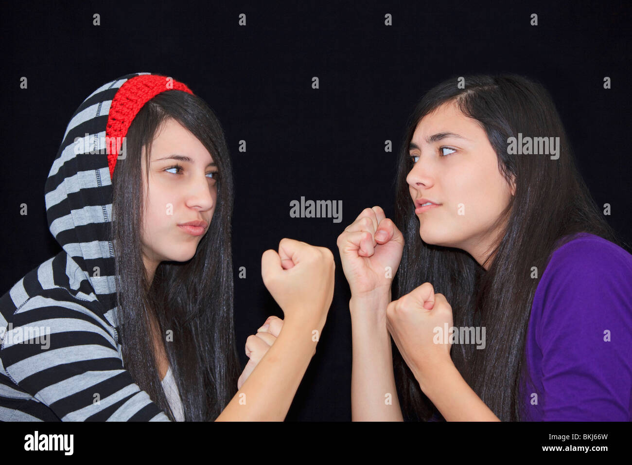 Teenage Girls Holding Up Their Fists To Fight Stock Photo - Alamy