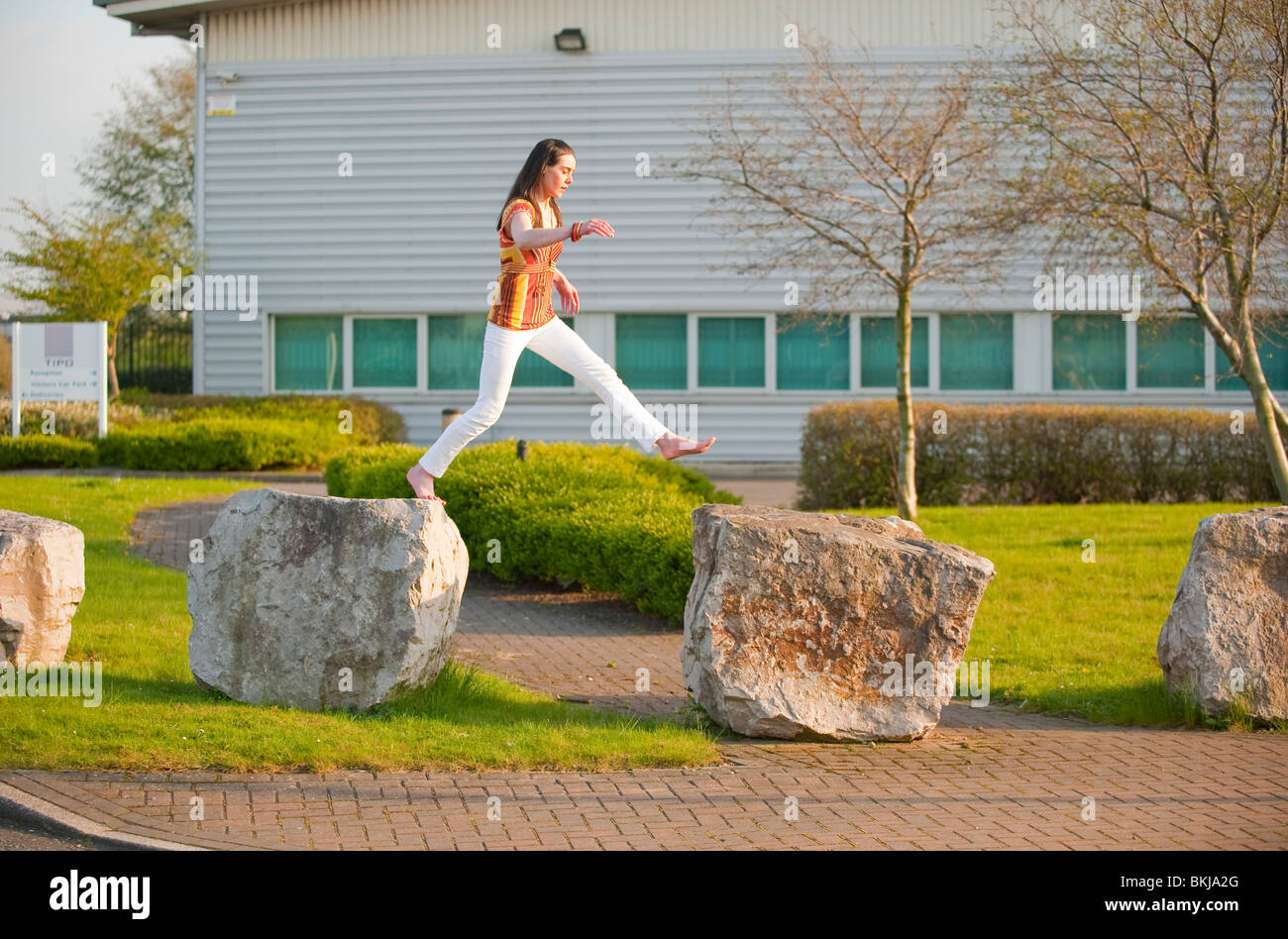 Young female model jumping from a rock FULLY MODEL RELEASED Stock Photo ...