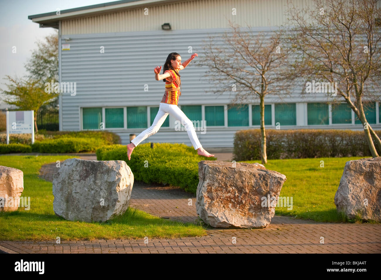 Young female model jumping from a rock FULLY MODEL RELEASED Stock Photo ...