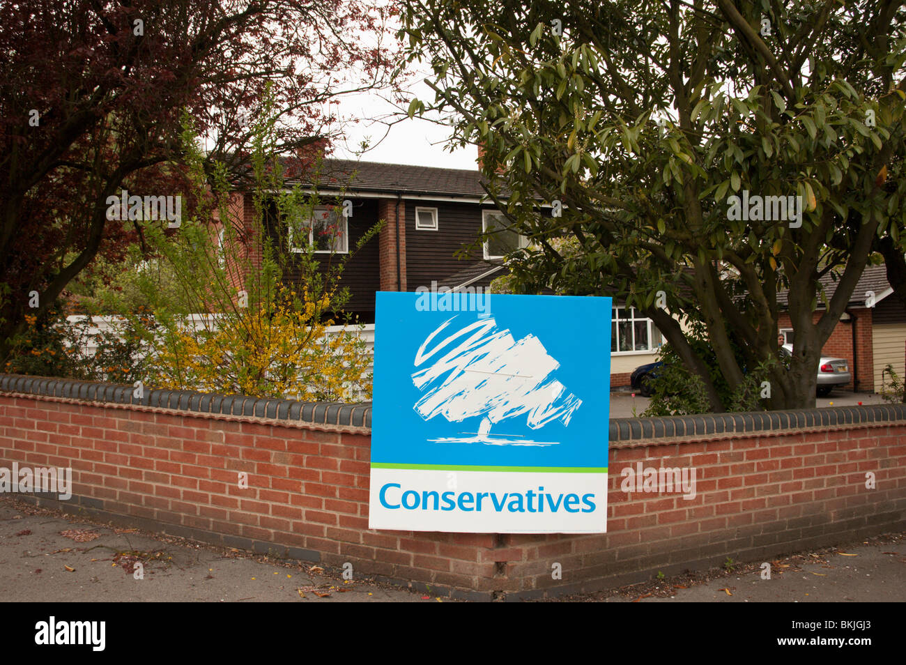 Conservative Party poster displayed on a private wall outside a house ...