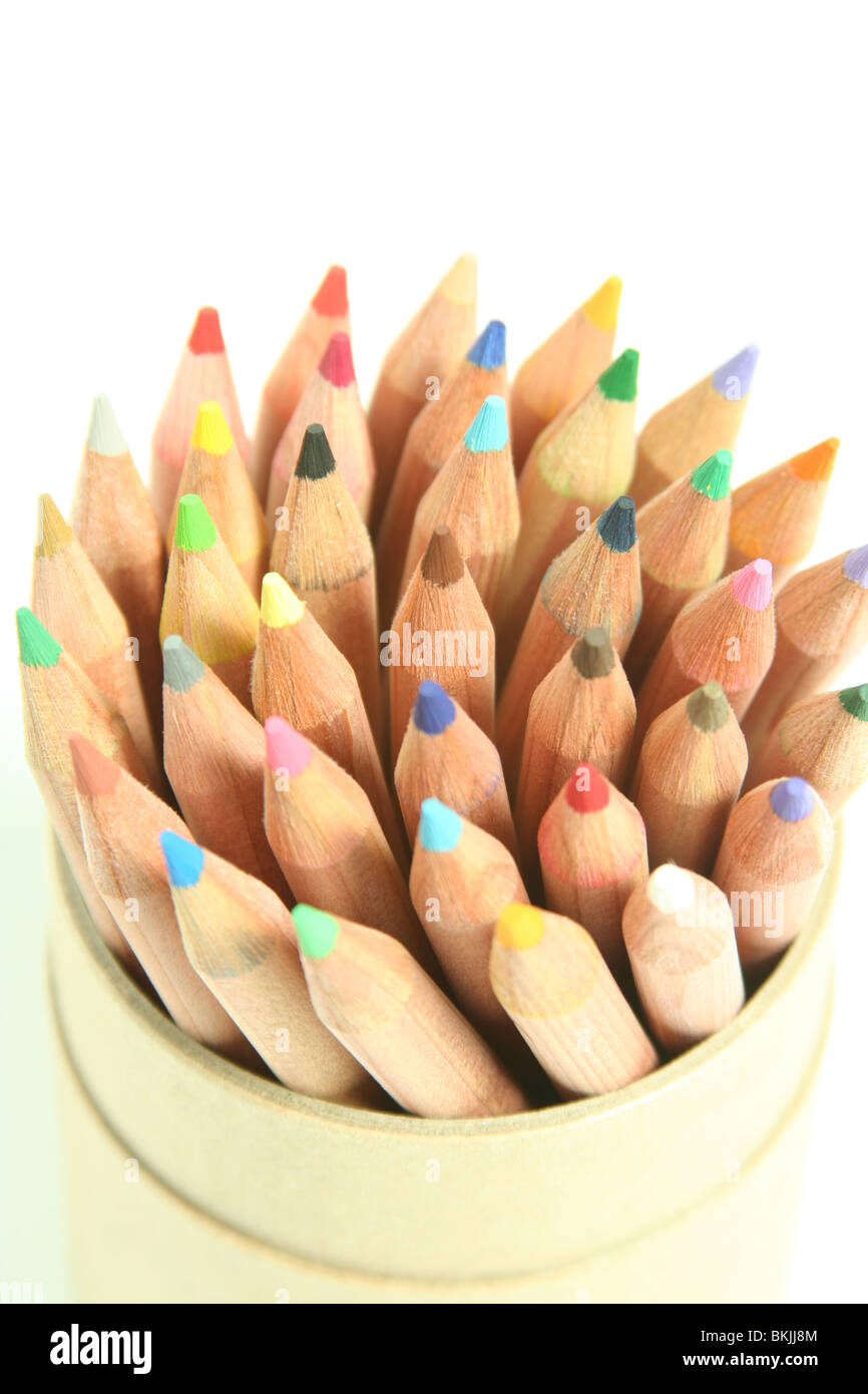 Colourful pencil crayons sat in a tub, pointing upwards in a spiral ...
