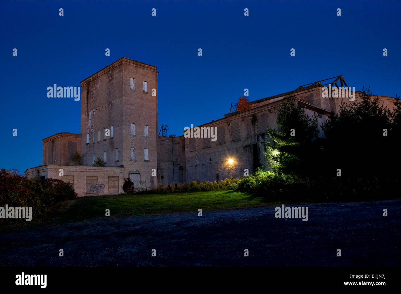 Old eerie abandoned warehouse at night Stock Photo - Alamy
