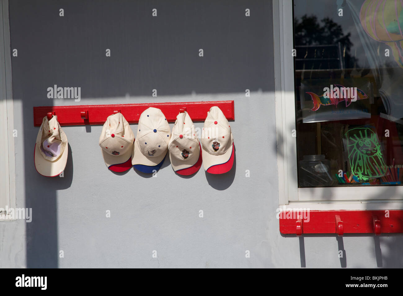 Caps hanging outside at Yenzi Shell school in Gabon Stock Photo - Alamy
