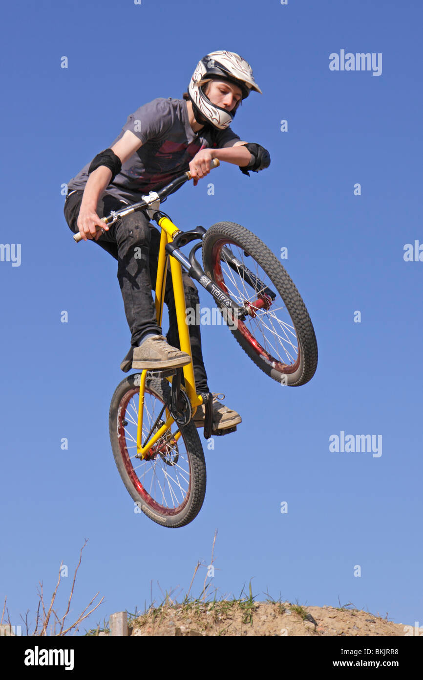 teenage boy jumping with his bike Stock Photo - Alamy