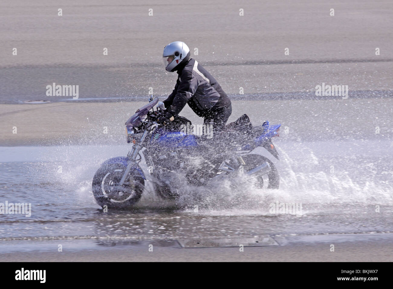 motor-cyclist riding through water during a driver safety training ...