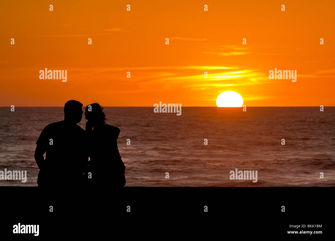 Man woman watching sunset over hi-res stock photography and images - Alamy