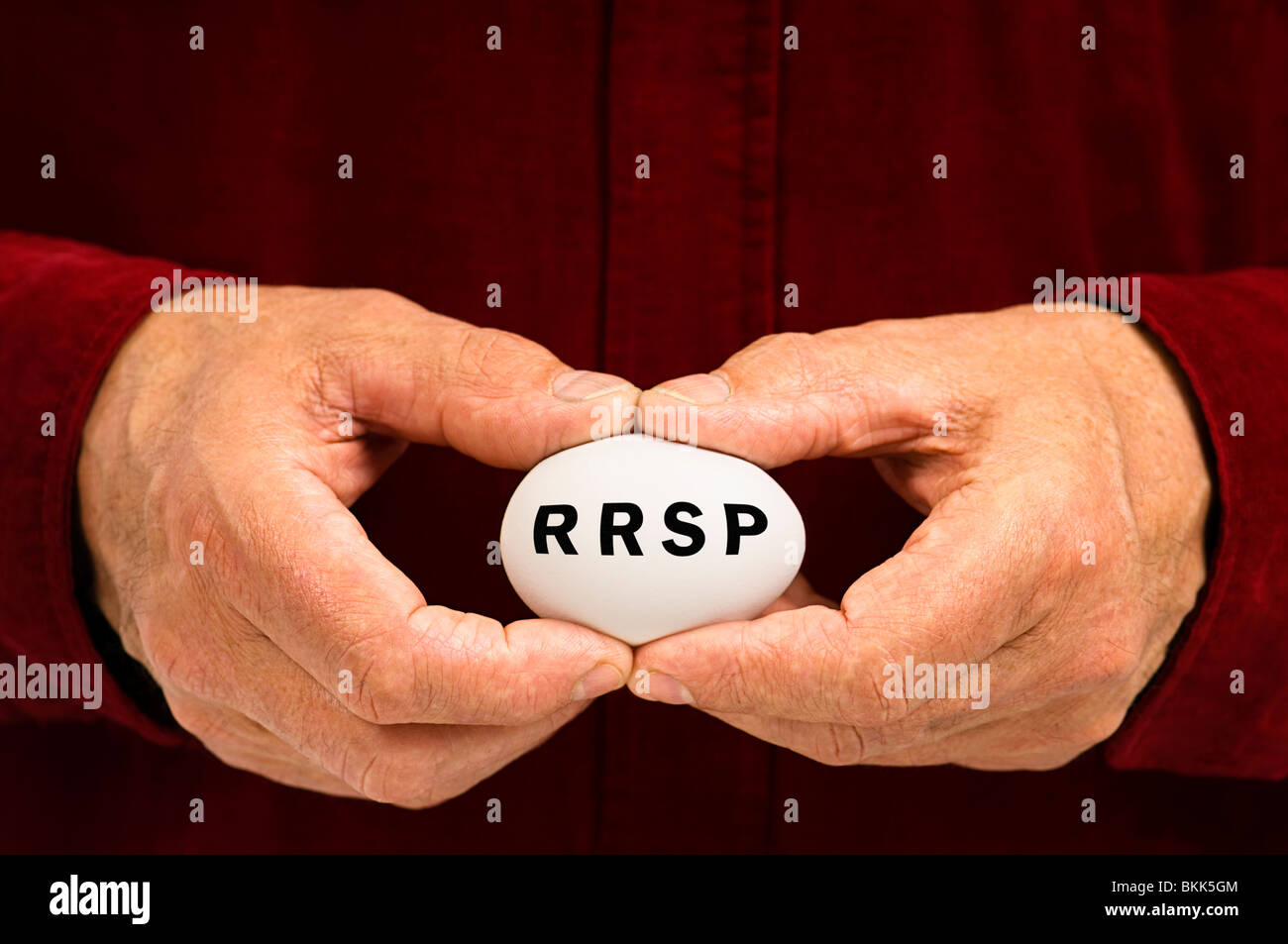 man-holds-egg-with-rrsp-written-on-it-a-registered-retirement-savings