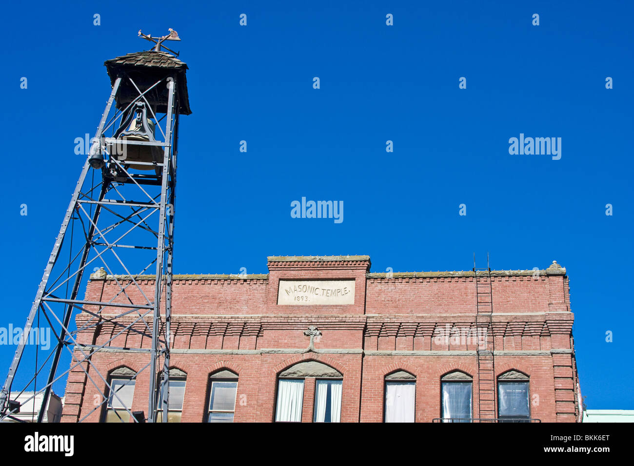 Historic old bell tower stands in front of Masonic Temple lodge along ...
